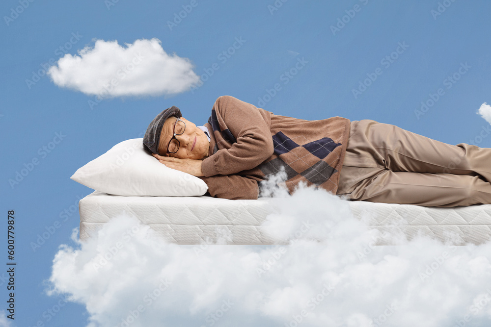 Elderly man sleeping on a matress and floating in a sky Stock Photo ...
