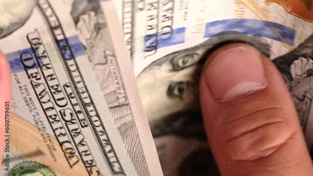 Close up, male hands counting a 100 dollar bills on blurred money ...
