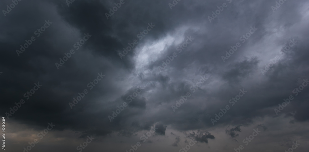 The dark sky with heavy clouds converging and a violent storm before ...