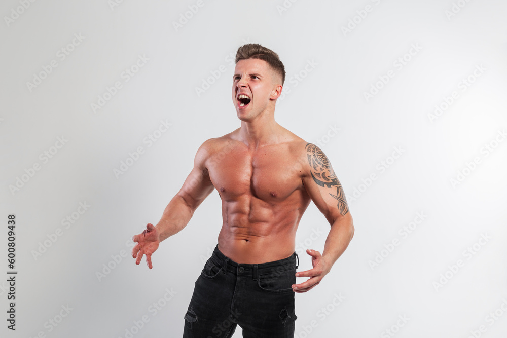 Handsome emotional man bodybuilder with muscular body screaming on ...