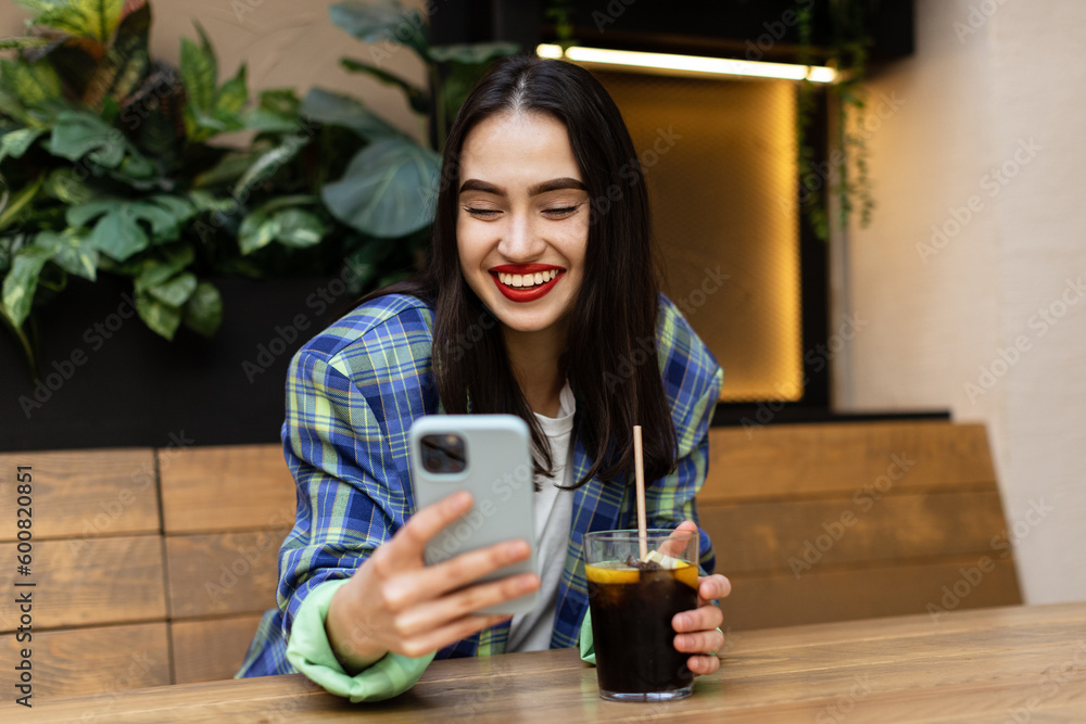 Happy zoomer multiethnic teen girl checking social media holding ...