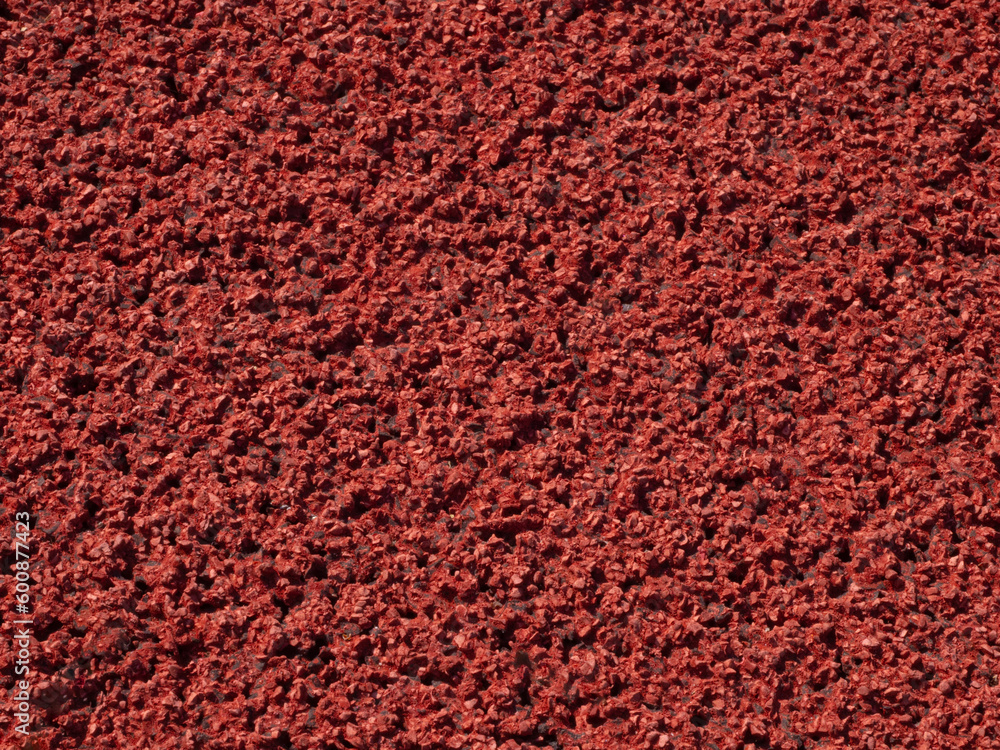 Textured background of a red sports surface on a running field. Rubber ...
