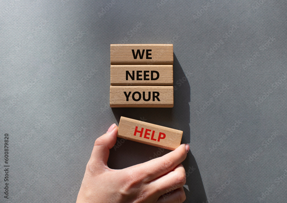 We need your help symbol. Wooden blocks with words We need your help ...