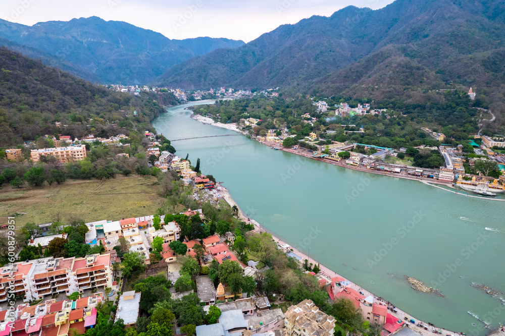 aerial drone shot over ram setu jhula suspension bridge with temples on ...
