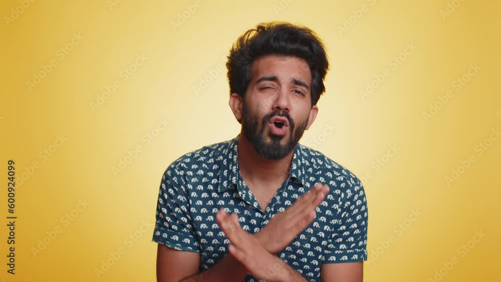 I am dont want it, not me. Confused young indian man pointing fingers ...