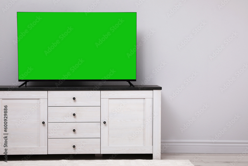 Foto de Chroma key compositing. TV with mockup green screen in room ...