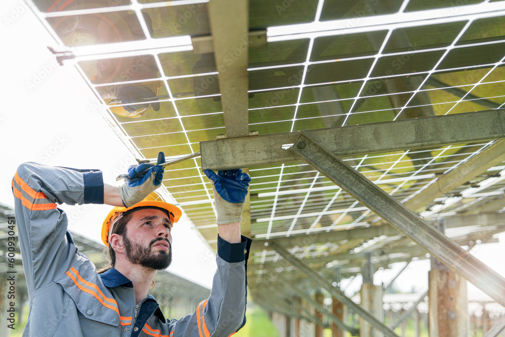 Factory engineer man checking and repairing solar panel construction ...