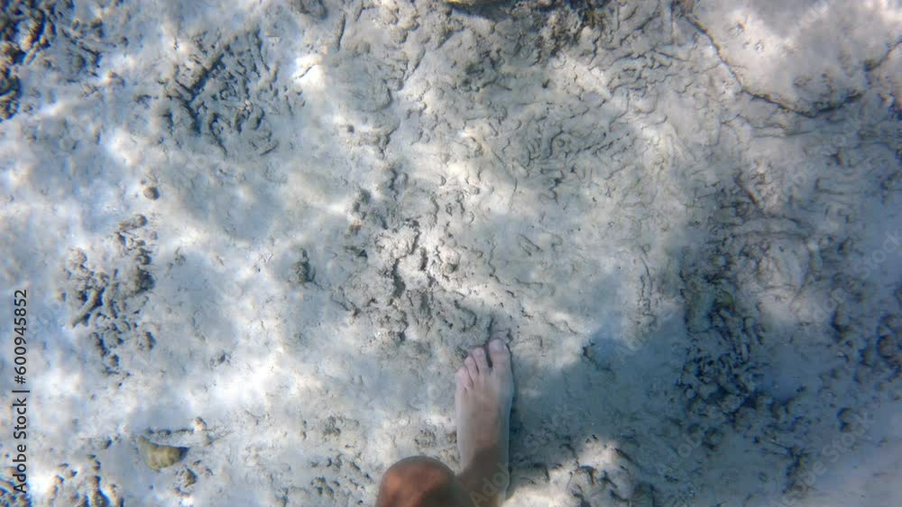 Pov of man walking with his bare feet on reef bottom of ocean in ...