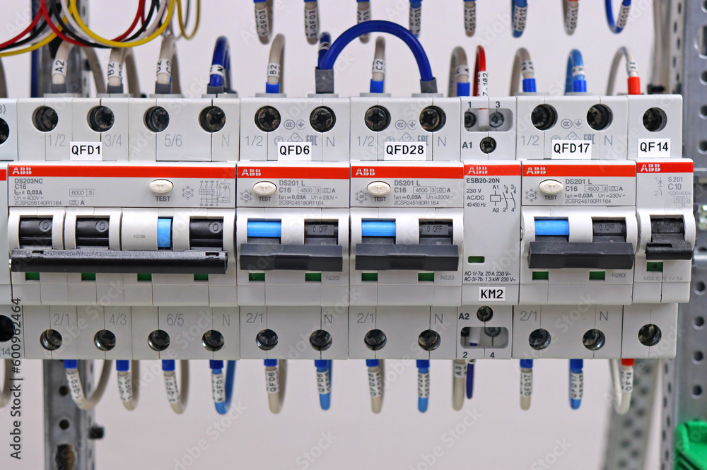 ABB electric circuit breakers installed on a din rail in an electric ...