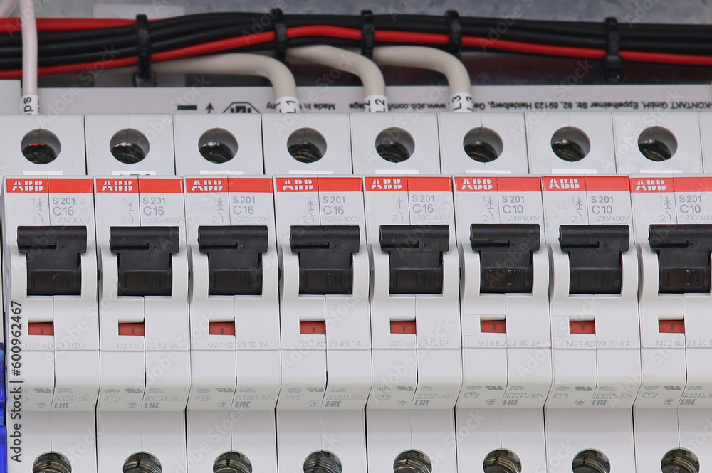 ABB electric circuit breakers installed on a din rail in an electric ...
