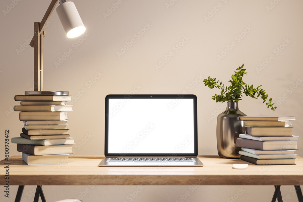 Front view of student wooden desk with white screen laptop and a lot of ...