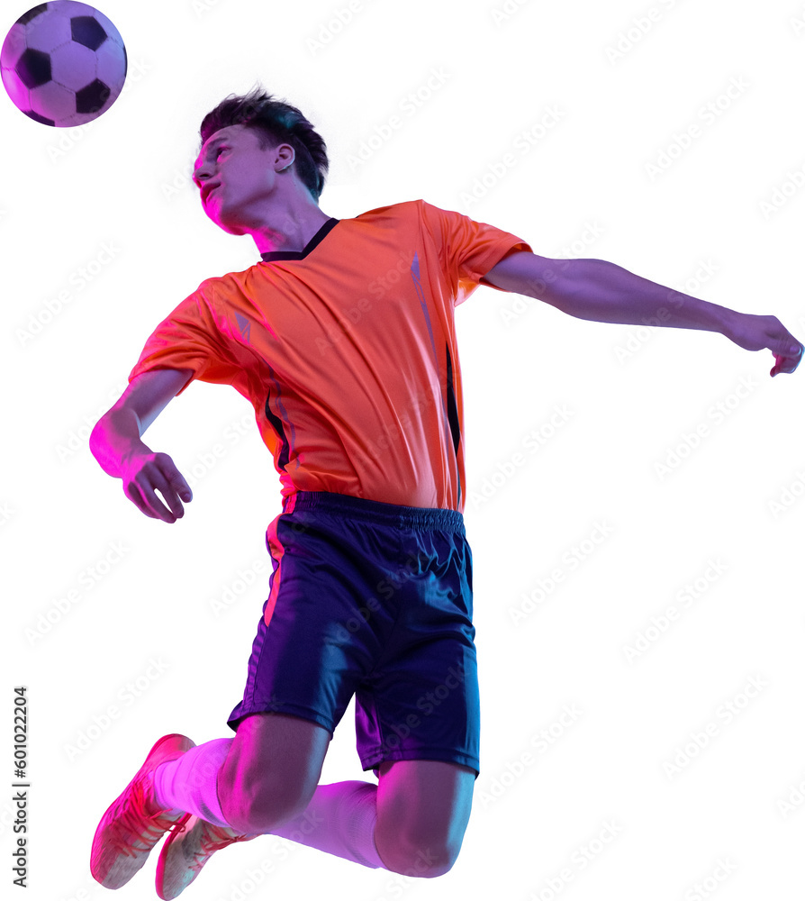 Young man, football player in unifrom, in motion, jumping with ball ...