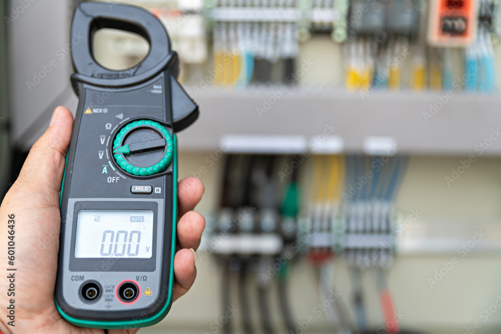Electrician use dijital clamp meter for repair electrical equipment ...