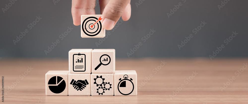 Business success goals Concept. Hand holding target board which ...