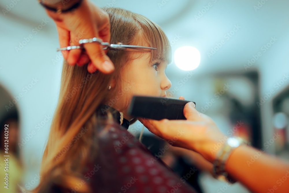 Little Girl Getting her Bangs Cute in a Professional Salon. Cute preschool child having a ...