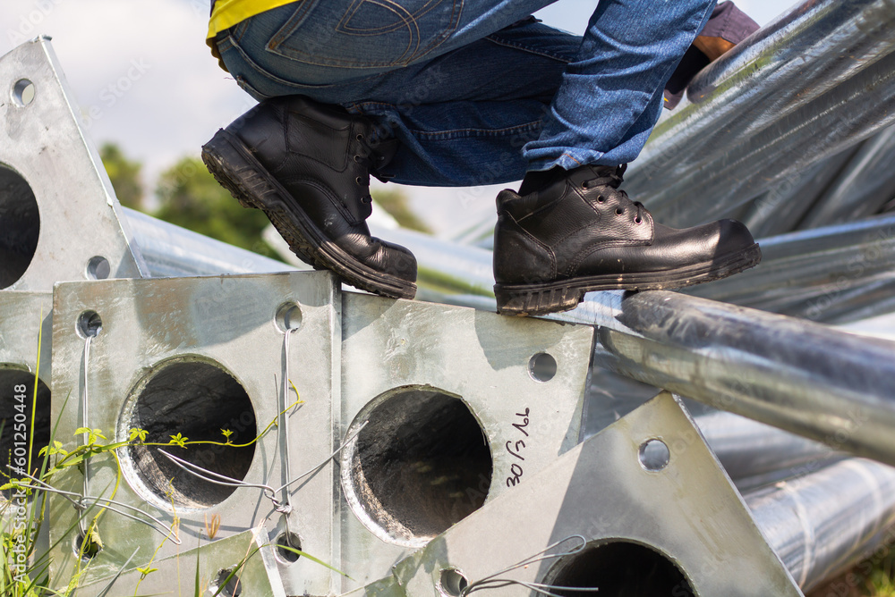 Wear safety shoes to ensure safety at work. construction workers wear ...