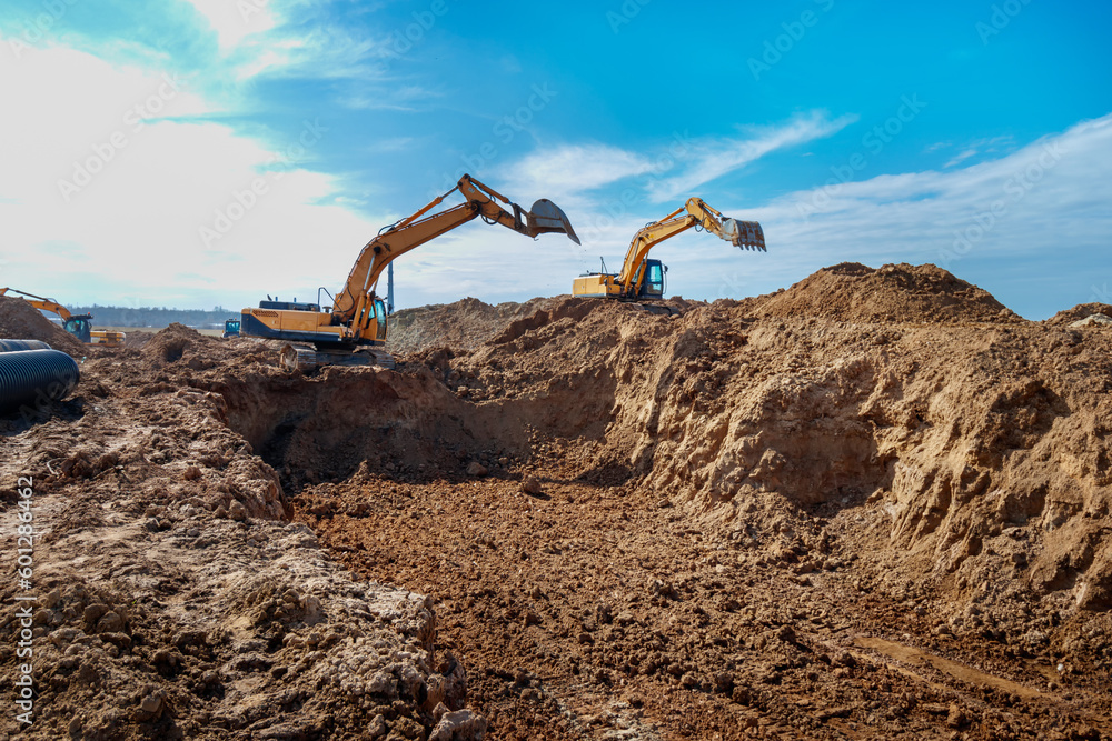 Two Excavator are digging soil in the construction site on sky ...