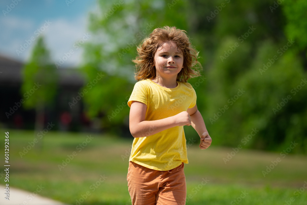 Cute kid boy running across american neighborhood street. Summer ...