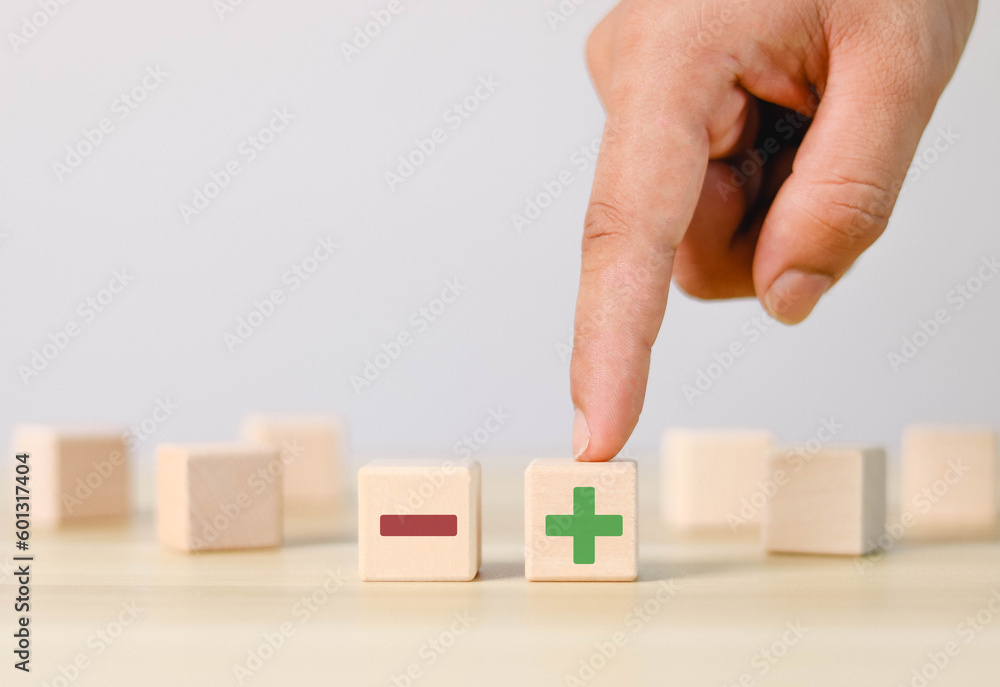 Wooden blocks showing plus and minus signs. The concept of antithesis ...