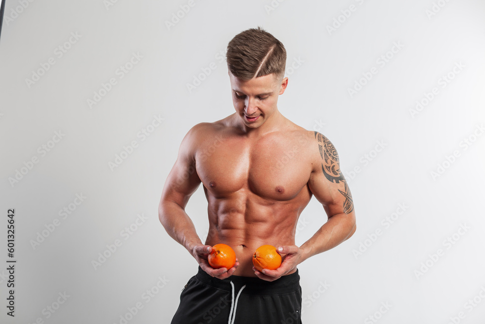 Handsome sporty fitness man with muscular body hairstyle holding ...