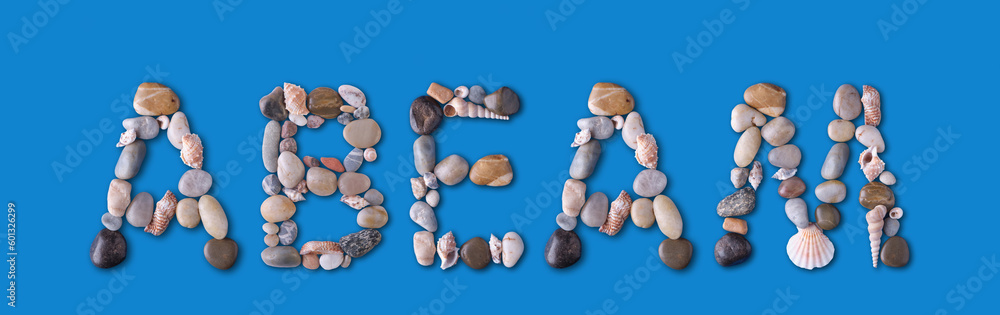 The word "ABEAM" is lined with shells and stones of different shapes ...