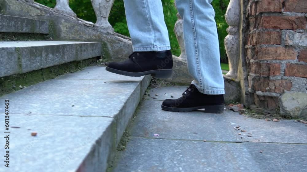 Vídeo do Stock: Woman legs in jeans walking on ancient stair side view ...