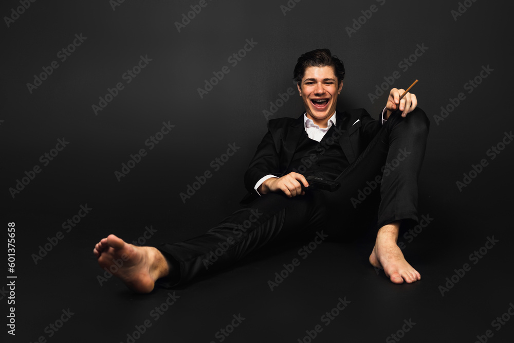 Insanely laughing Young mafia member with a slicked back hair, in black ...