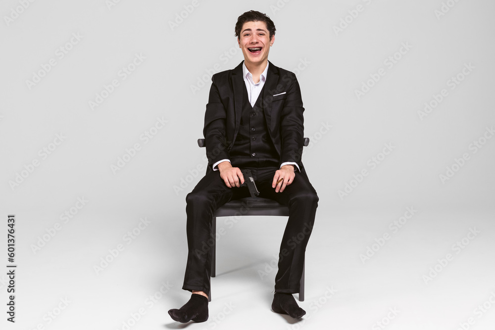 Crazy, insanely laughing Young mafia member with a slicked back hair ...