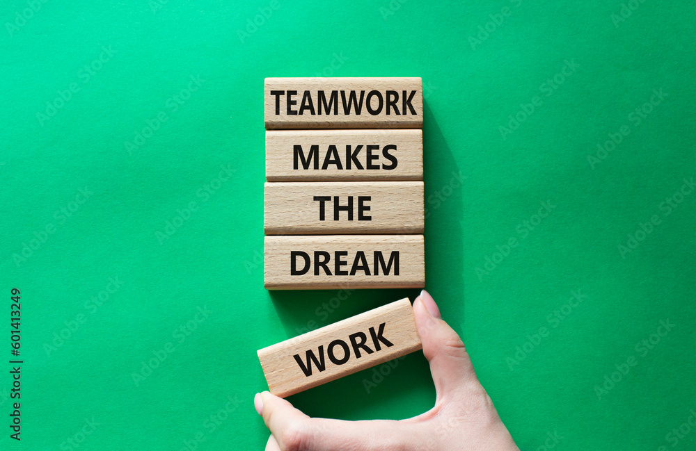 Teamwork symbol. Wooden blocks with words Teamwork makes the Dream work ...