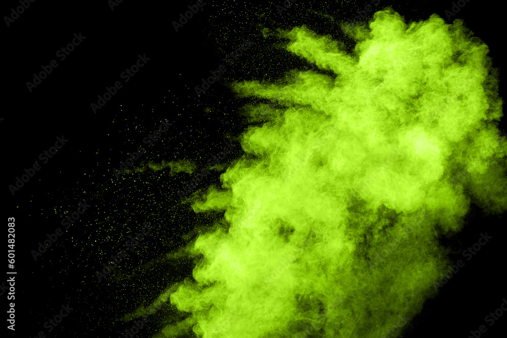 Green color powder explosion cloud on black background.Green dust ...