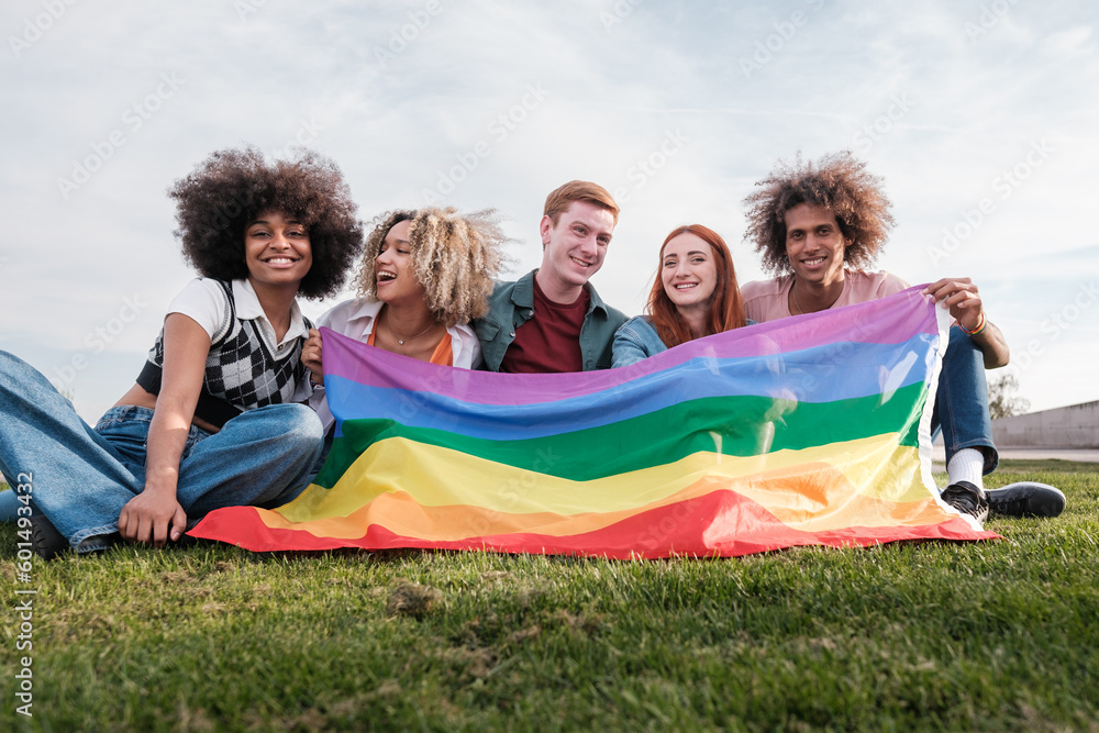 Heterogeneous and diverse group of young friends holding the lgtbi flag ...