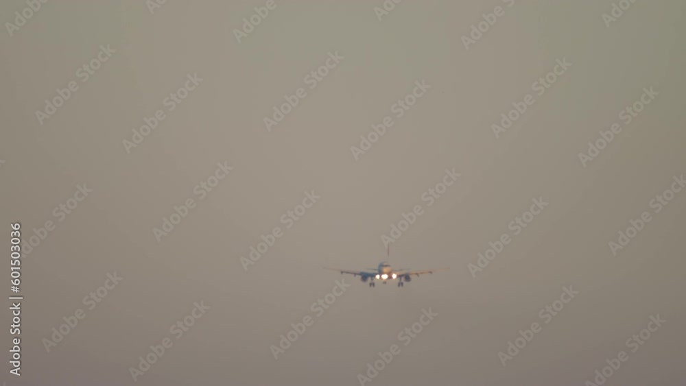 Aircraft approaching landing in beautiful sunset or sunrise. Long shot ...