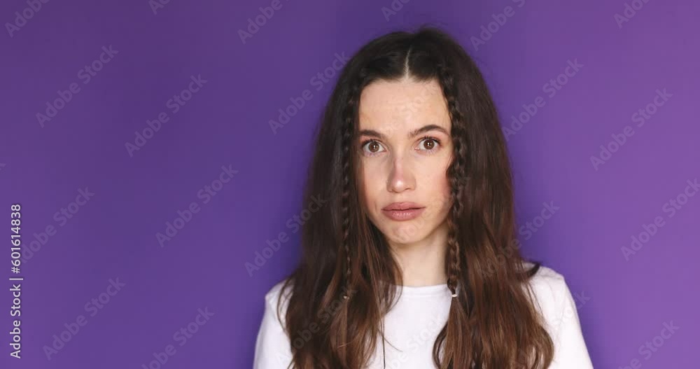 Serious brunette curly woman with braids placing finger hand on lips ...