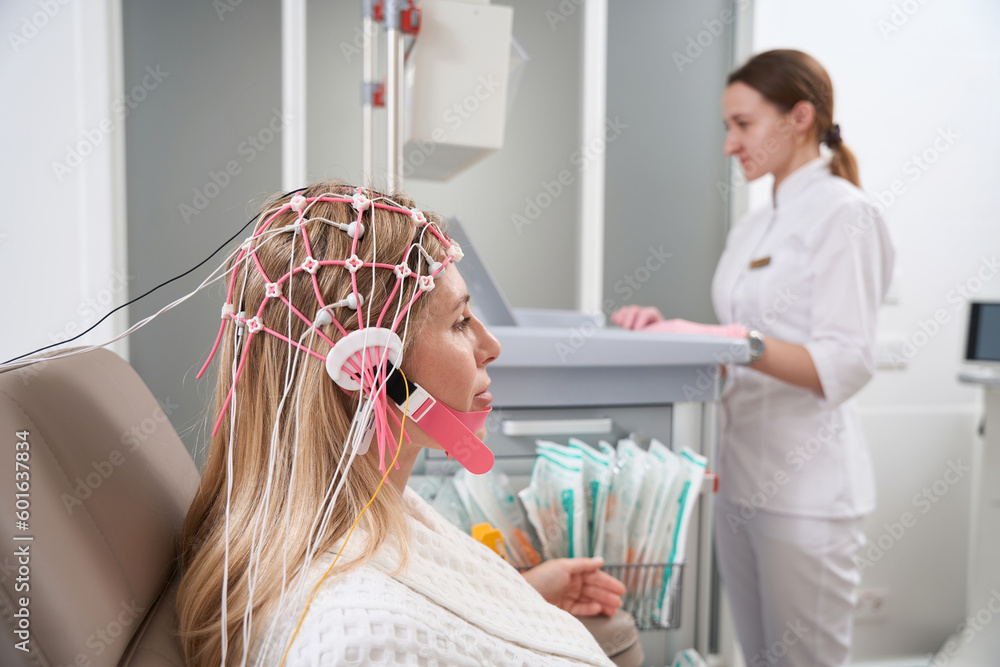 Poster Diagnostician conducts electroencephalogram procedure young ...