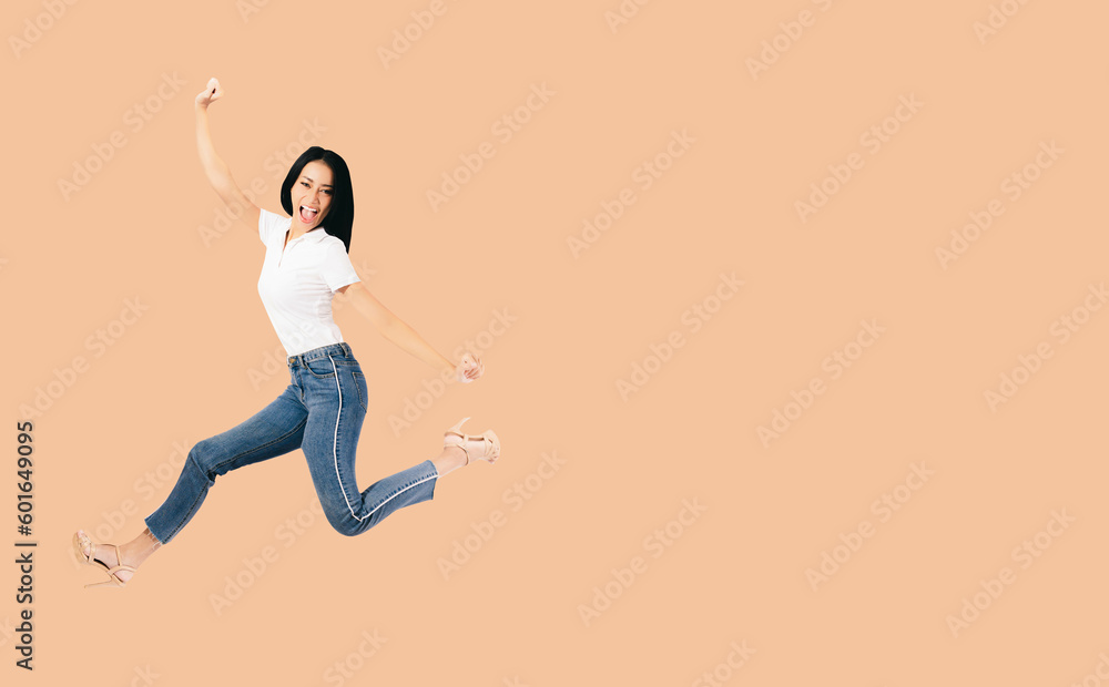 Cheerful positive asian lady jumping on air raised fists hand look at ...