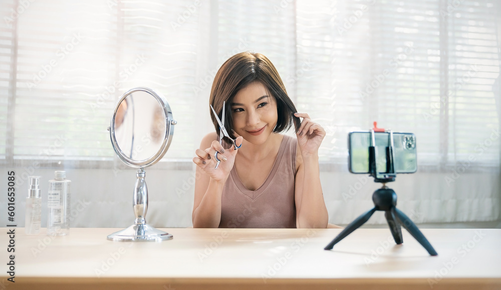 Asian woman show how to cut hair with scissors to fan following channel ...