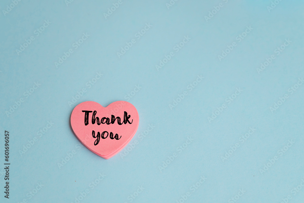 Thank you message on a pink heart sticky note on blue background Stock ...