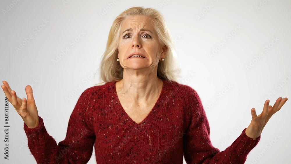 Angry, scared, confused senior mature middle age woman put hands out ...
