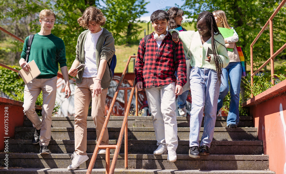 International high school students walking together outside of school ...