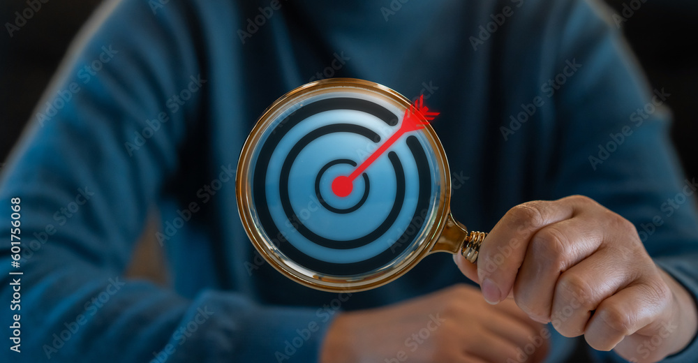 Hand holding magnifier glass for focus target icon business, target ...