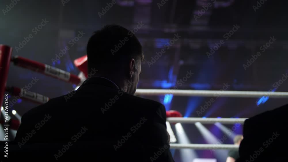 The presenter speaks into the microphone against the background of the ...