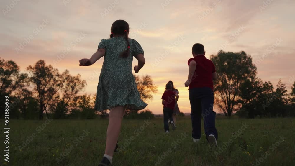 Child freedom of play, nature. Childrens team run together in park ...