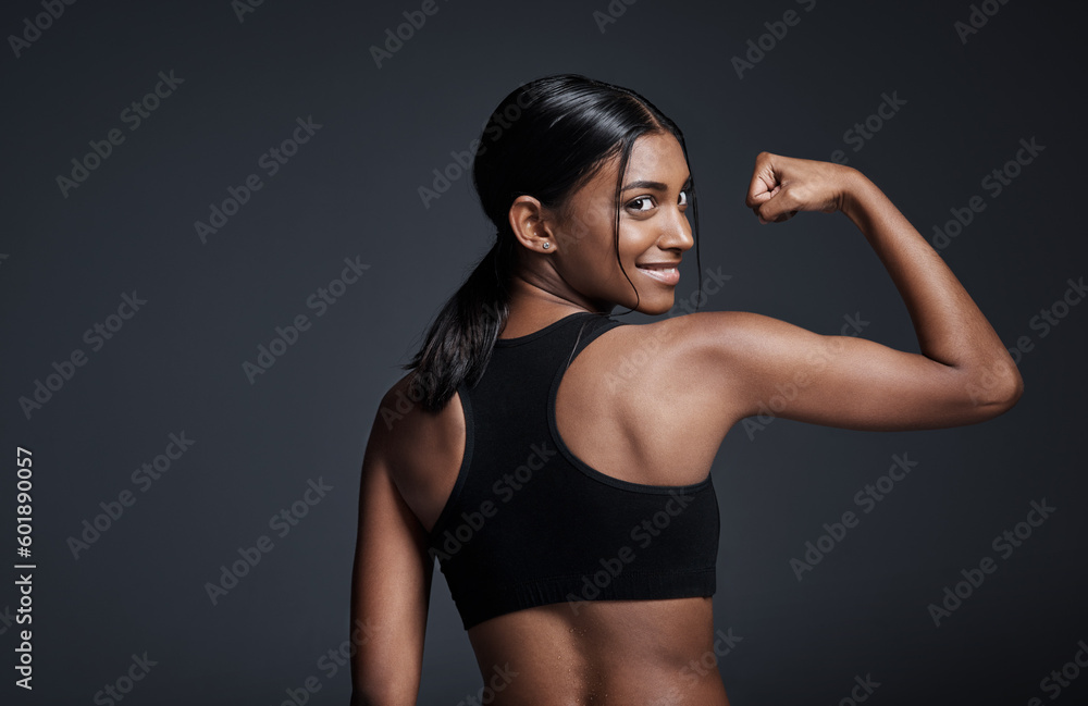Portrait, happy and woman flexing back in studio isolated on a black background mockup. Strong ...