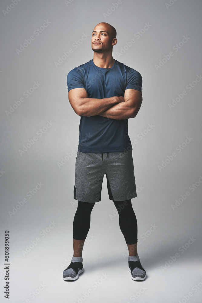 Arms crossed, fitness and man thinking isolated on studio background ...