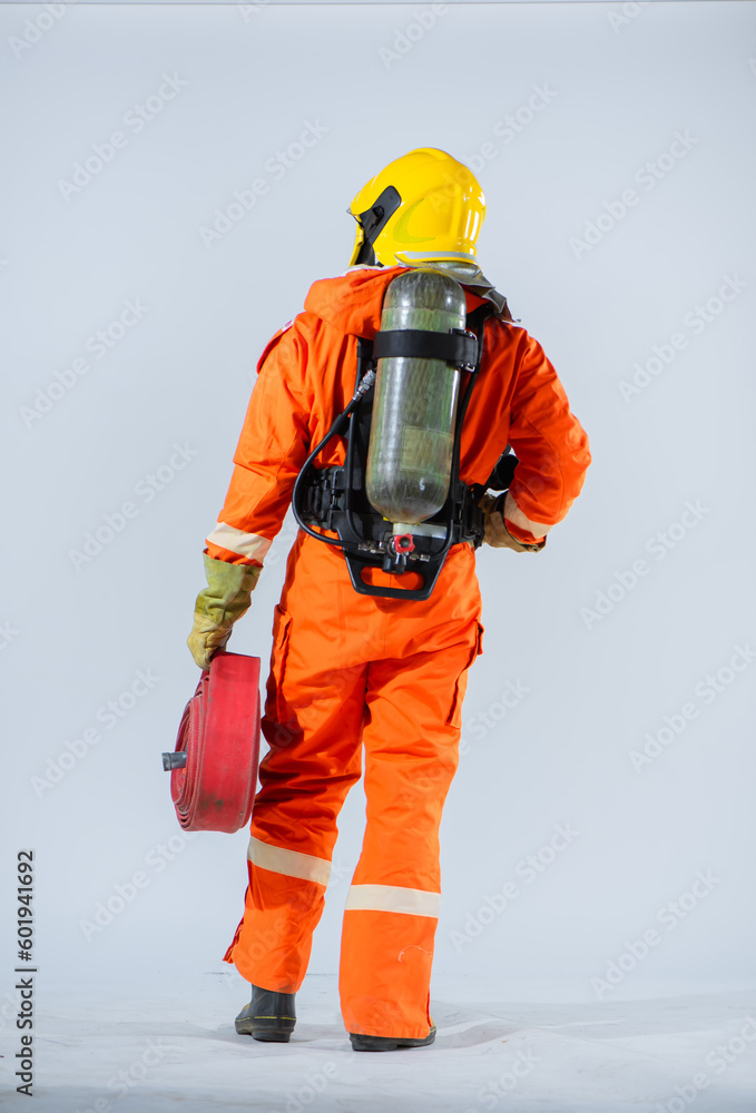 Vertical picture of the firefighter stood tall and confident adorned in ...