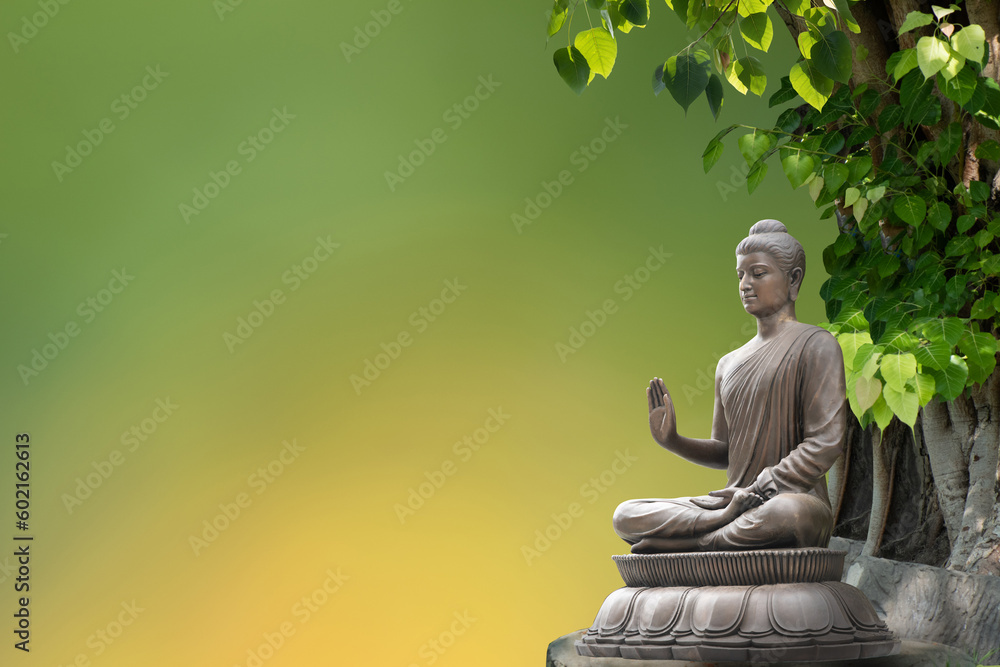 Buddha statue sitting under the bodhi tree on nature background. Stock ...