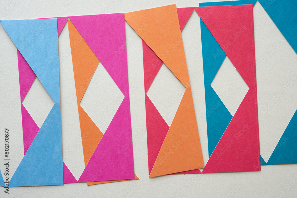 cut paper card with diamond shape cutouts overlapping on blank beige ...