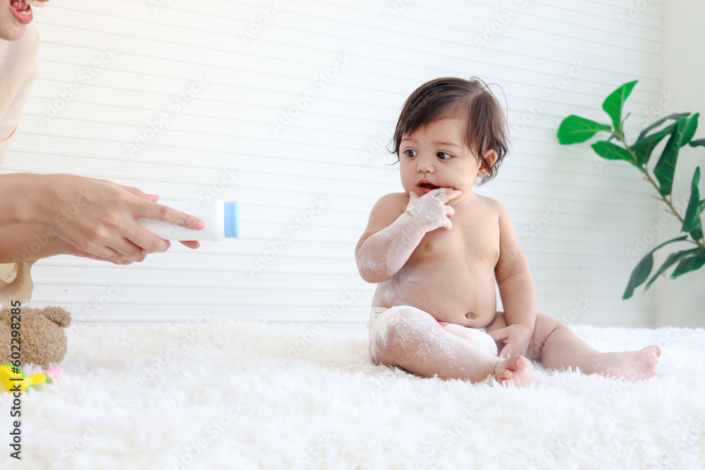 Portrait of happy smiling toddle baby girl sit on fluffy white rug with ...