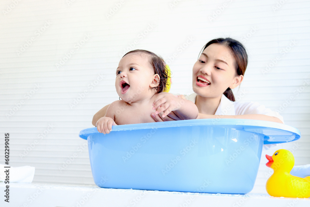 Happy toddle baby infant has fun while taking bubble bath in bathroom ...