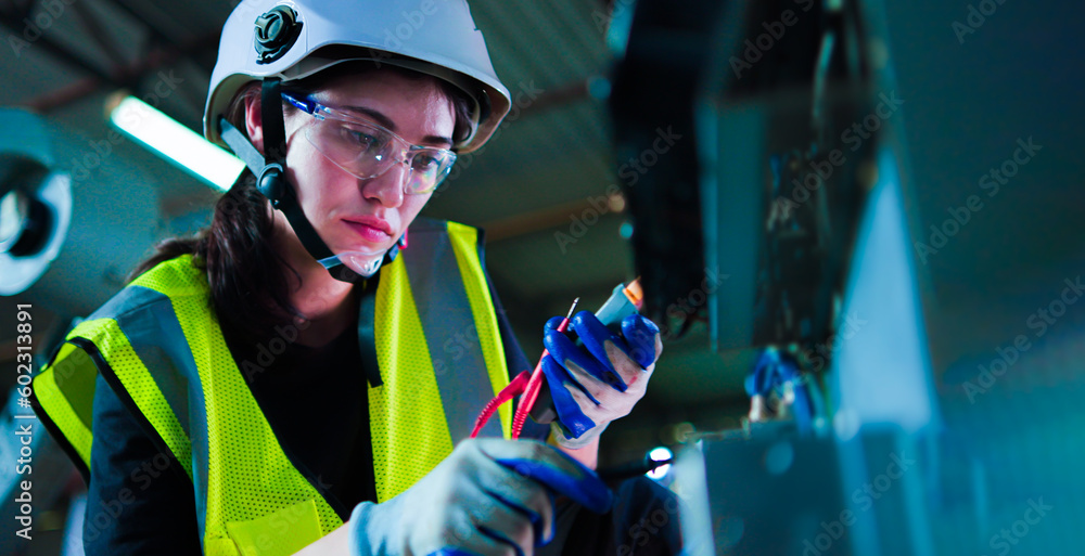 Female electrical engineer working control check meter voltage and ...